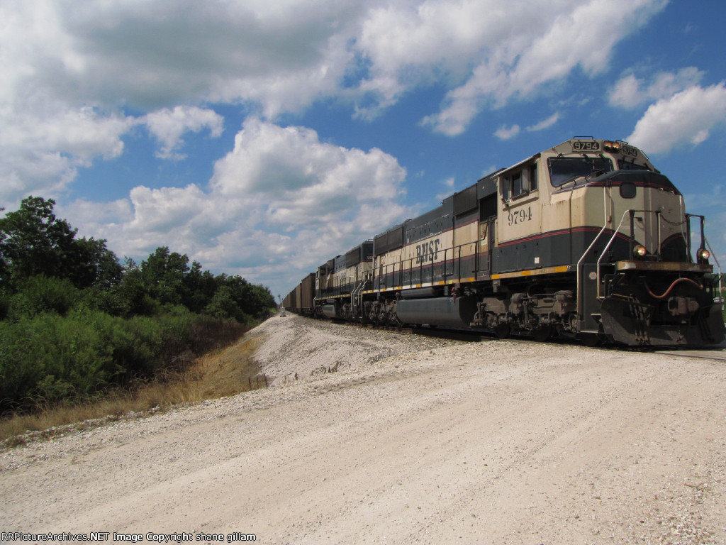 BNSF 9794 leads a coal load sb,